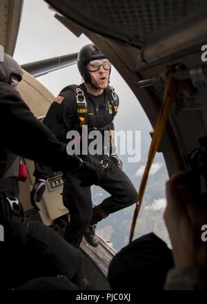 A U.S. Army free fall parachutist prepares for landing on the drop zone ...