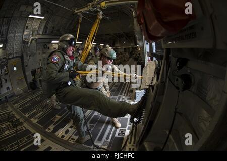 US Navy Personnel pull a line across the flight deck of the Nimitz ...