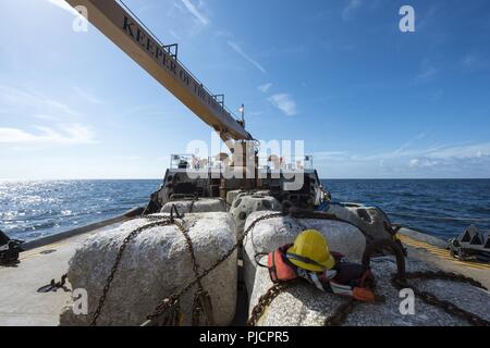 Coast Guard Cutter Maria Bray crew members prepare to deploy a concrete ...
