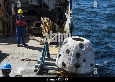 Coast Guard Cutter Maria Bray crew members prepare to deploy a concrete ...