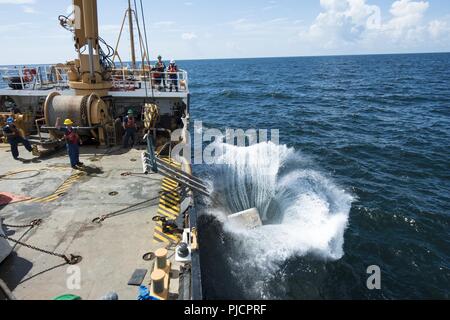 A Coast Guard Cutter Maria Bray crew member gives the signal to deploy ...