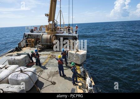 Coast Guard Cutter Maria Bray crew members prepare to deploy a concrete ...