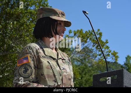 Col. Karen Monday-Gresham, incoming 4th Brigade commander (right) holds ...