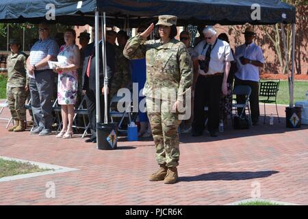 Col. Karen Monday-Gresham, incoming 4th Brigade commander (right) holds ...