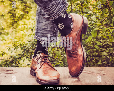 Office Manager in stylish shoes, blue pants and bright, colorful socks ...