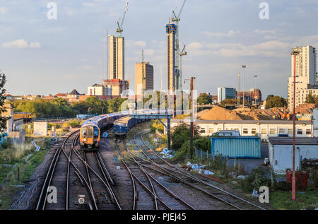 Changing skyline of Woking, Surrey: railway tracks lead to tower cranes ...