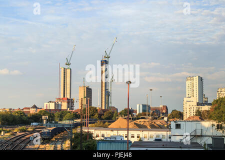 Changing skyline of Woking, Surrey: railway tracks lead to tower cranes ...