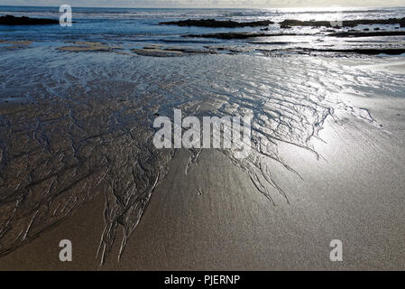 Patterns in yellow beach sand caused by water erosion Stock Photo - Alamy