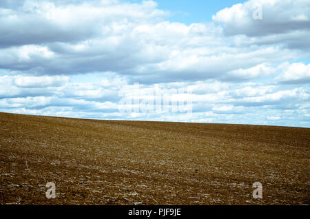 scary view to dark ploughed field and gray sky landscape Stock Photo ...