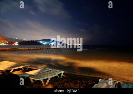 Holiday resort by night in Kusadasi, Turkey. Aegean Sea and beach in ...