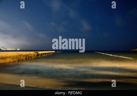 Holiday resort by night in Kusadasi, Turkey. Aegean Sea and beach in ...
