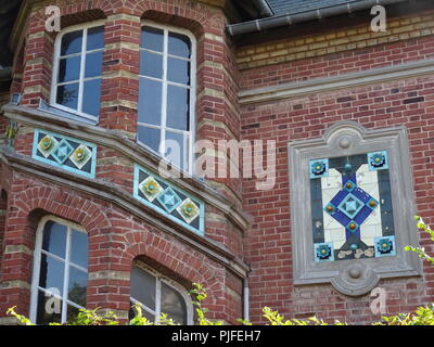 Old fashion beach stone house with bright red closed shutters alongside ...