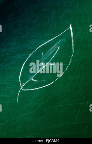 A photo of a line with a piece of chalk on a dark blackboard with copy ...