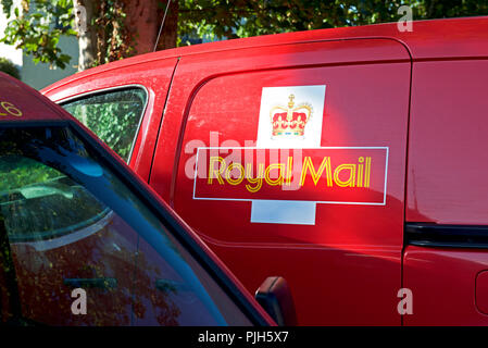 A Royal Mail post delivery van parked in the street outside a Stock ...
