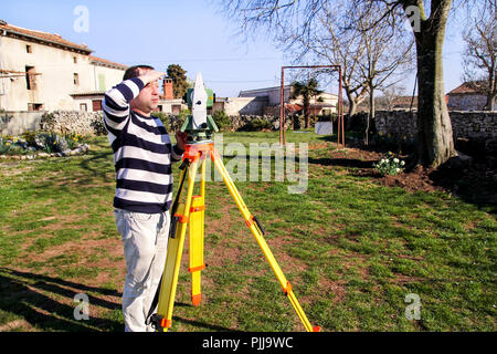 Man using of total station. Guy surveyor at work. Survey Instrument ...