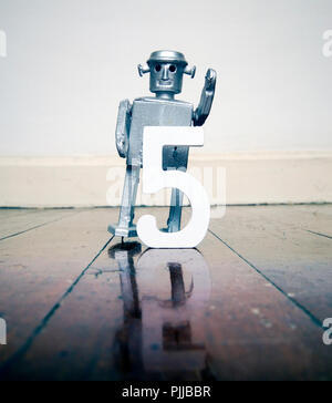 number 5 robot toy on a woden floor with reflection Stock Photo - Alamy