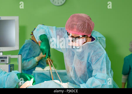 cosmetic liposuction surgery in actual operating room, group of ...