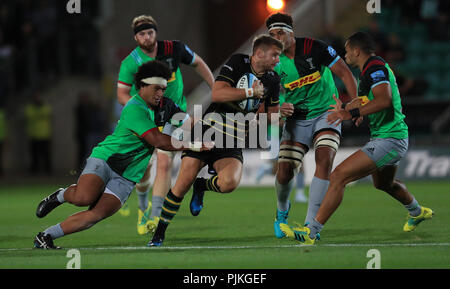 Northampton Saints' Dan Biggar is tackled by Harlequins' Nick David ...