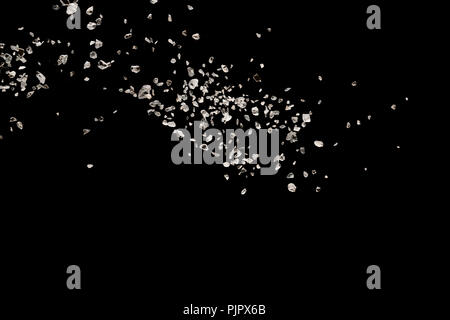 Split debris of stone exploding against black background Stock Photo ...