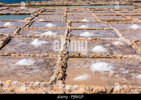 Harvesting sea salt from the ancient salt pans in Marsalforn, Gozo ...