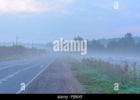 Drive out of town on a foggy autumn morning. Russia, Leningrad region ...