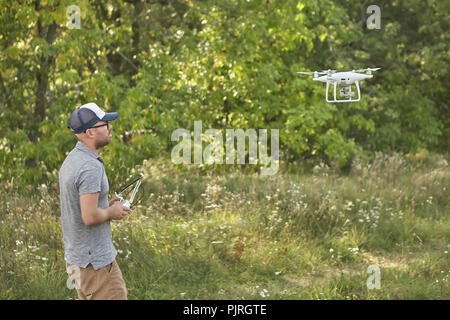 Man manages quadrocopters. Remote control for the drone in the hands of ...