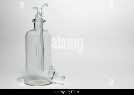 water filled composite test tube with two curved glass pipes, out from ...
