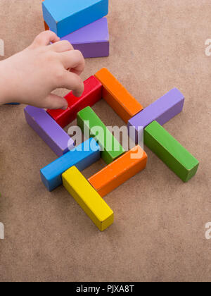 Colorful building blocks on a brown background Stock Photo - Alamy