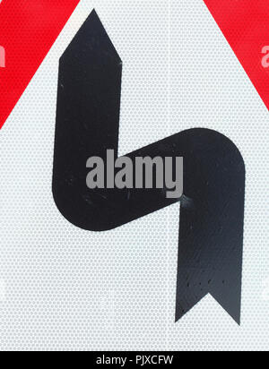 Double bend first to right road sign in Britain Stock Photo - Alamy