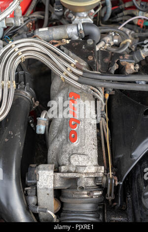 Close up mechanical red braided hose curve over motorcycle engine part ...