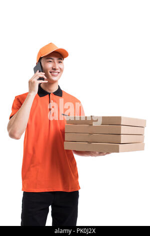 Cheerful pizza delivery person talking on cell phone Stock Photo - Alamy