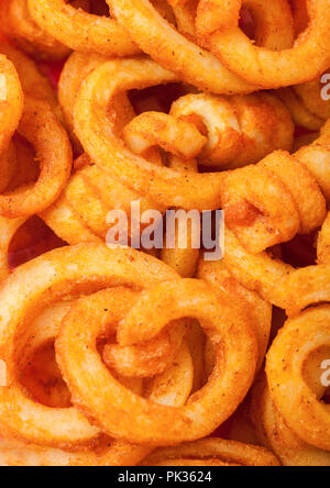 Curly fries fast food snack in red plastic tray with glass of cola on ...