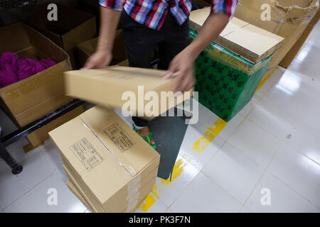 Clothes being boxed up ready for collection from a garment factory in ...