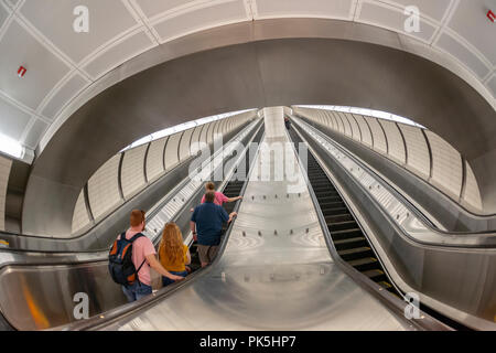 Deep level escalators in a train station underground in Singapore Stock ...