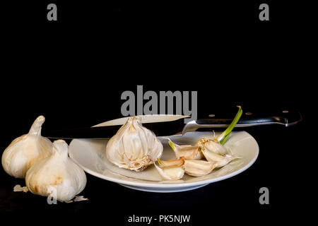 Garlic clusters and cloves closeup isolated on black background Stock ...