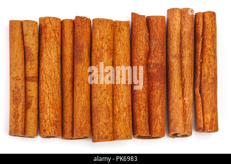 Several cinnamon sticks insolated on white background Stock Photo - Alamy