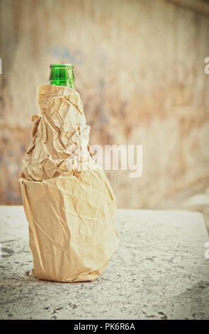 Alcohol bottle. Wrapped in paper. Lies on pine boards Stock Photo - Alamy