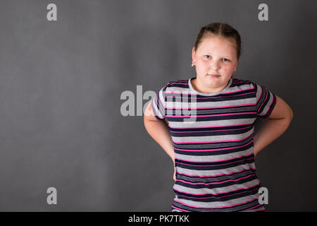 Strong stout girl with arms akimbo Stock Photo - Alamy