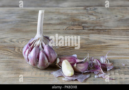 Rustic style. Garlic and a few cloves of garlic on a wooden kitchen ...