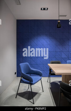 Stylish conference room with gray and blue walls Stock Photo - Alamy