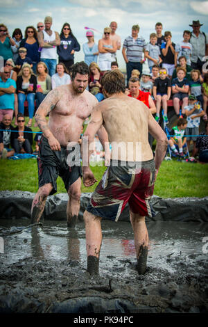 Two men mud wrestling at a mud fighting competition at The LowLand ...