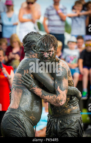 Two men mud wrestling at a mud fighting competition at The LowLand ...