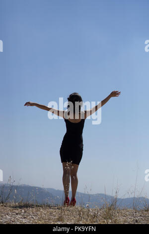 Female figure standing with outstretched arms at the foot of the Angel ...
