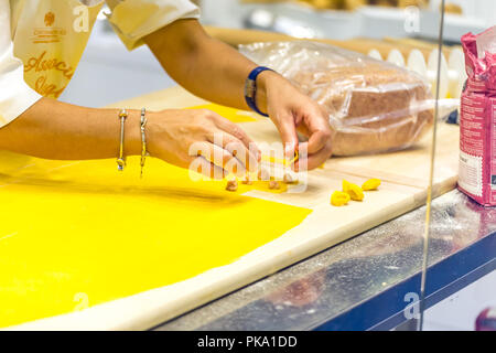 BOLOGNA (ITALY), SEPTEMBER 10, 2018: booth presenter is preparing ...