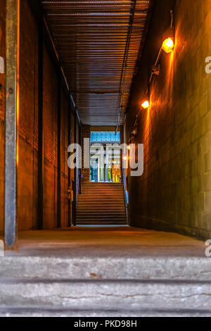 Narrow corridor in between to buildings overlooking an interior patio ...