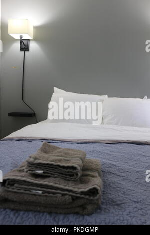 Simple student-style dorm bedroom with lots of light Stock Photo - Alamy