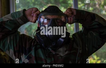 A U.S. Marine breaks the seal of his M50 joint service general purpose ...