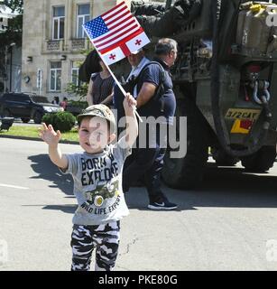US and Georgian servicemen, with Georgian and US flags in front, take ...