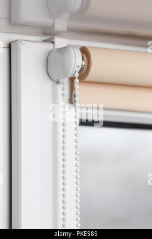 Beige blackout roller blind on the white plastic window. Shutters on ...