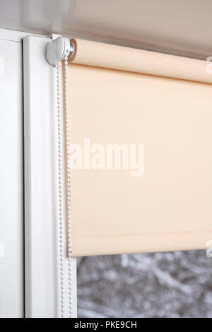 Beige blackout roller blind on the white plastic window. Shutters on ...